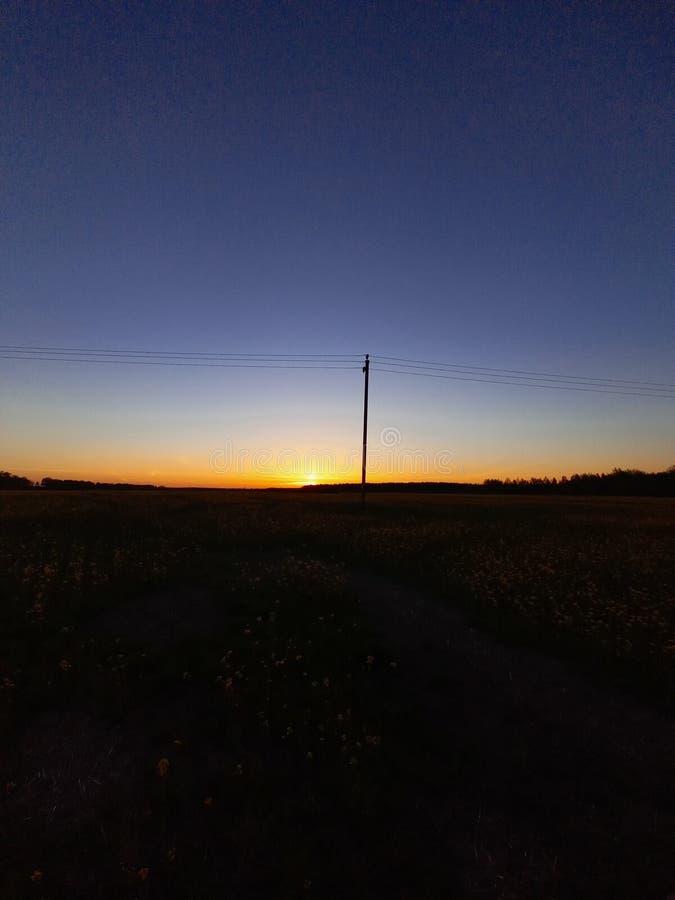Sunset over the field stock image. Image of lighting - 219304511