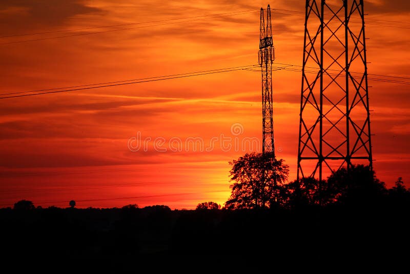 Sunset Over Field with Electrical Poles Stock Photo - Image of deep ...