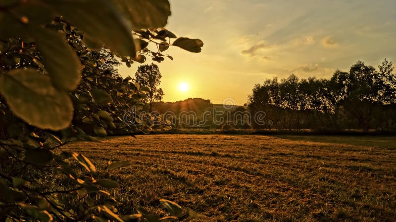 Sunset over a field stock image. Image of clouds, field - 74339443