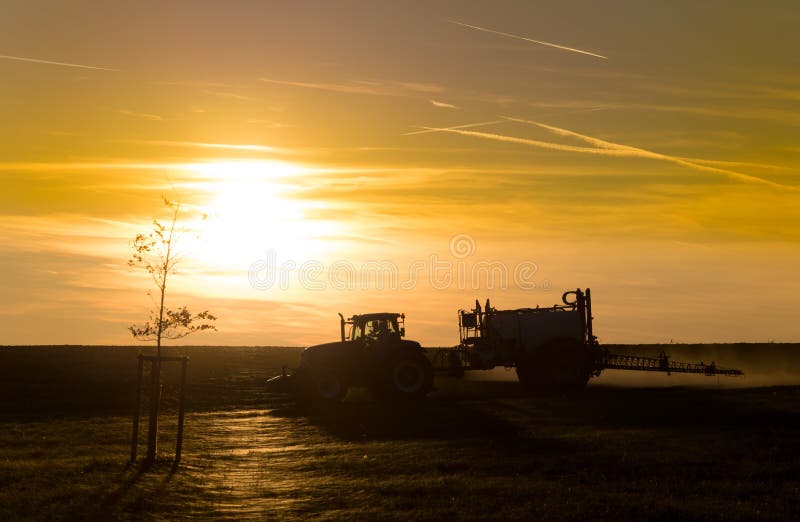 Sunset Over a Field with Tractor Stock Image - Image of sunshine, rural ...