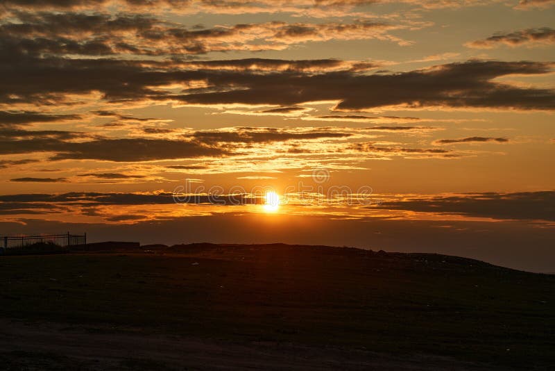 Sunset Over Grassy Hill and Dramatic Clouds. Stock Image - Image of ...