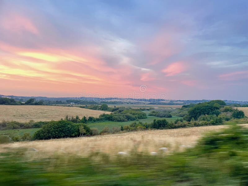 Sunset Over Hills and Fields Stock Photo - Image of sunset, grass ...