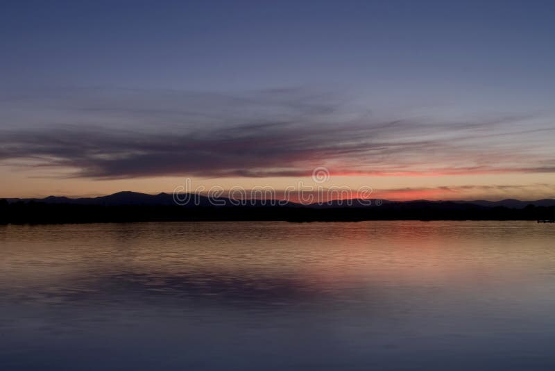 Sunset over a Lake stock image. Image of blue, sunset, mountains - 610543