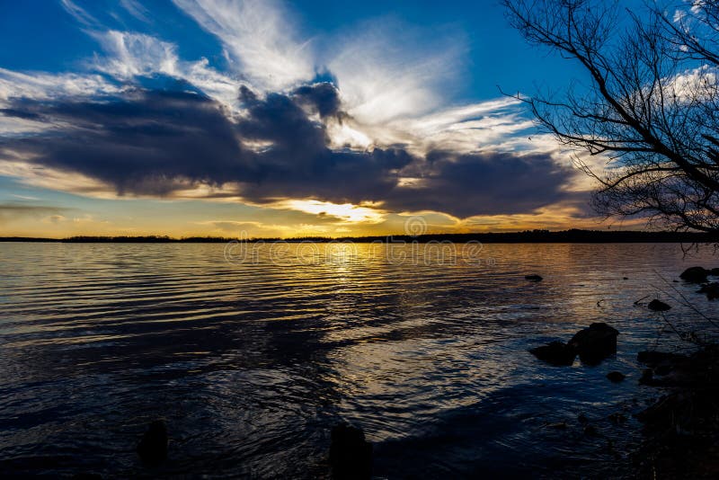 Sunset Over a Lake stock image. Image of bright, season - 242582797