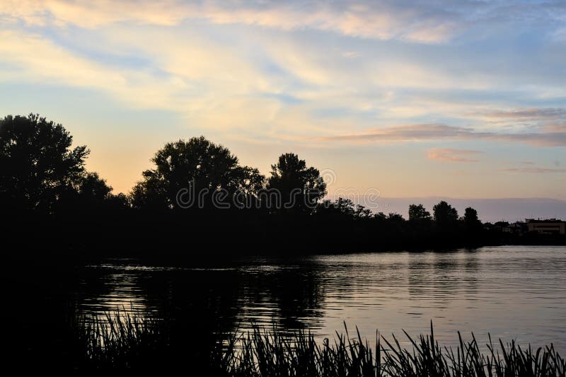 Sunset Over a Lake with a Forest in the Distance in Autumn Stock Photo ...