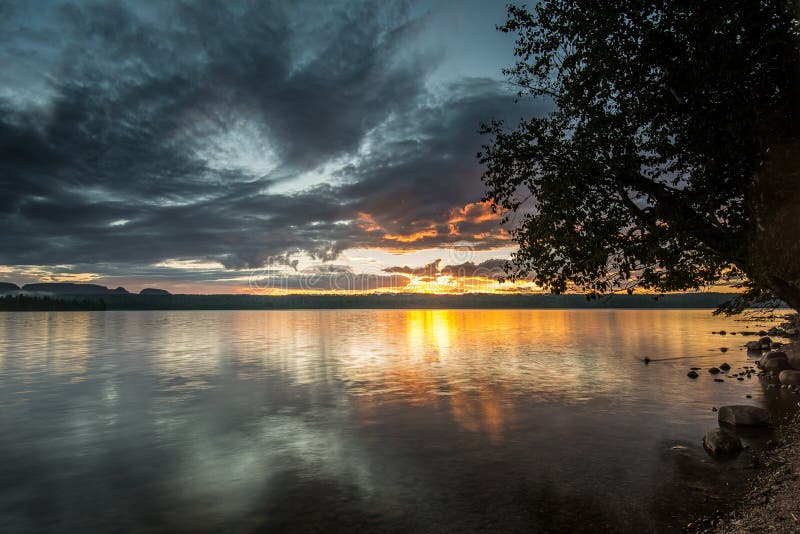 Sunset over the lake stock photo. Image of yellow, spectacular - 68407174