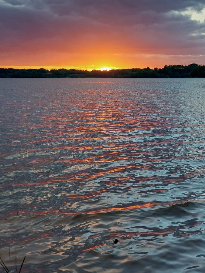 Sunset Over the Lake. Pink Light on Blue Waves Stock Image - Image of ...