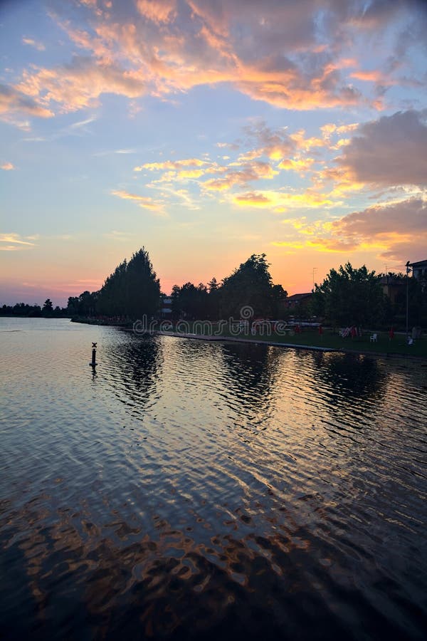 Sunset Over a Lake in Summer with Silhouette of the Shores Stock Photo ...