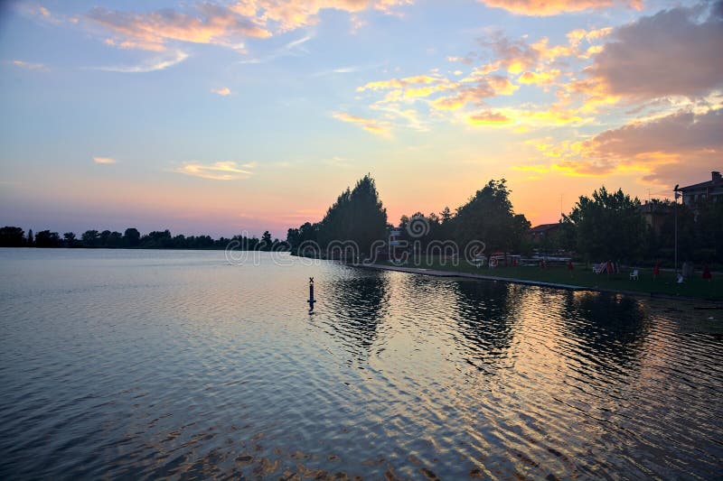 Sunset Over a Lake in Summer with Silhouette of the Shores Stock Photo ...