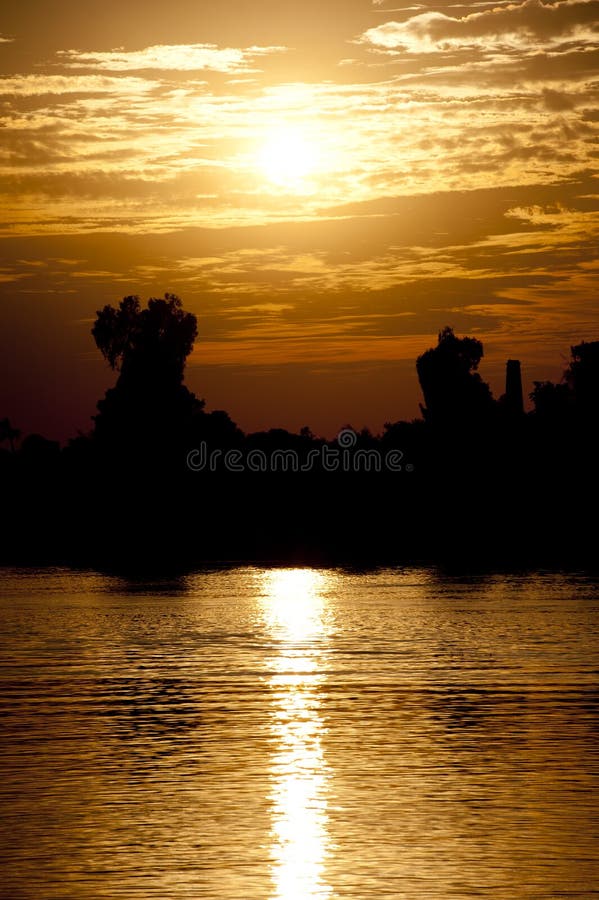 Sunset over a large river stock photo. Image of sunset - 23208180