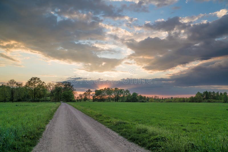 Sunset over a meadow stock image. Image of clouds, beam - 77216295
