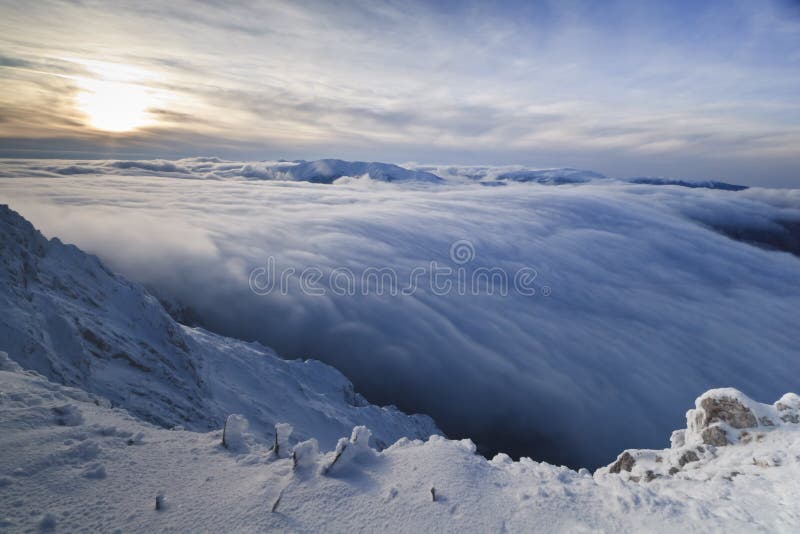 Sunset Over the Mountains and Clouds in Winter Stock Photo - Image of ...