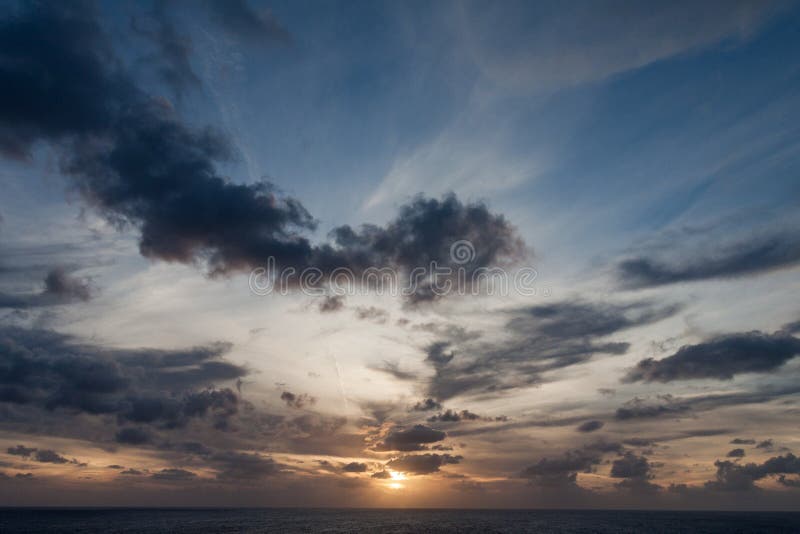Sunset Over the Ocean with Dark Clouds Stock Image - Image of sunset ...