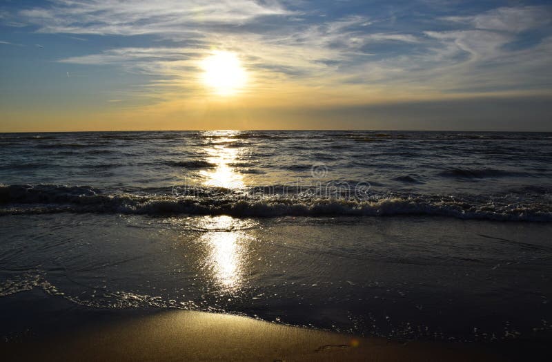 Sunset Over the Ocean - View of the Red Sun Sinking into the Horizon ...