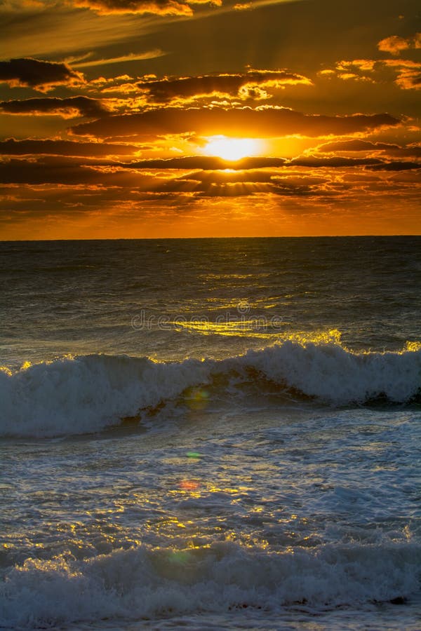 Sunset Over the Ocean with Waves Vertical Stock Photo - Image of ...