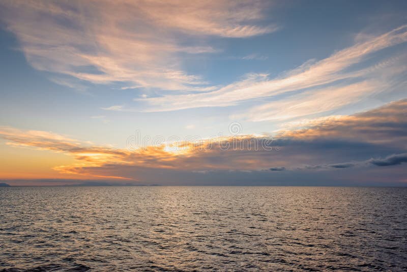 Sunset Over Ocean in Wide Angle View with Reflection on Water Stock ...
