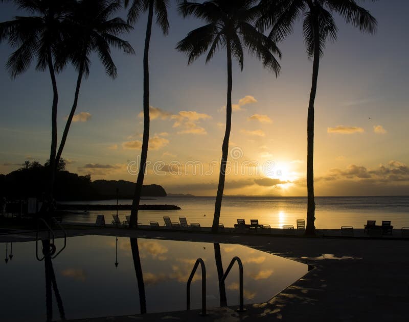 Sunset Over Pool and Beach with Clouds Reflected in Pool and Trees in ...
