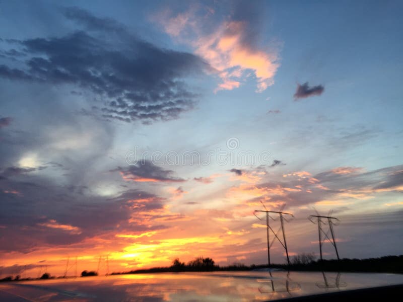 Sunset over the powerlines stock image. Image of sunset - 82490695