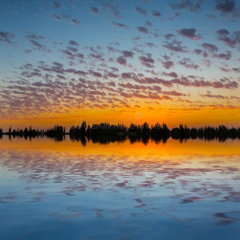 Sunset over a quiet lake stock image. Image of pond - 102023941