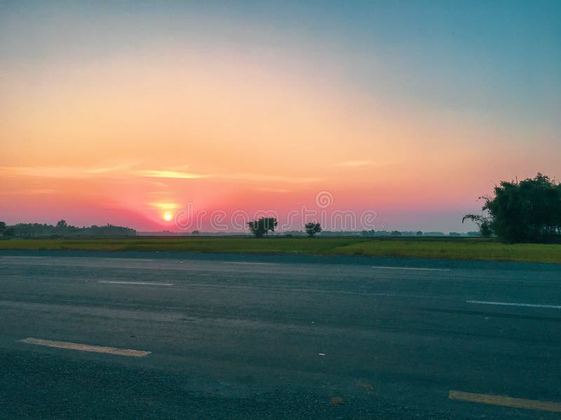 Sunset over road in terai stock image. Image of sunset - 144551153