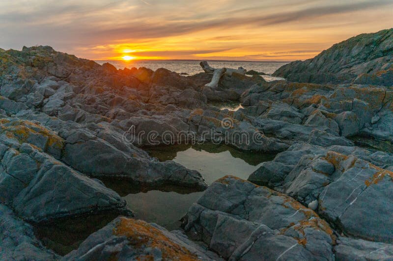 Sunset over rock pools stock image. Image of coastline - 148859915