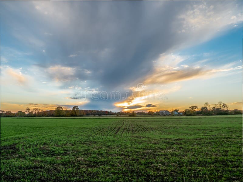 Sunset Over Rural Farm Field Stock Image - Image of colors, sunset ...