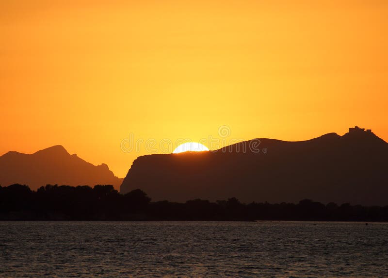 Sunset Over the Sea with Promontory in the Background Stock Photo ...
