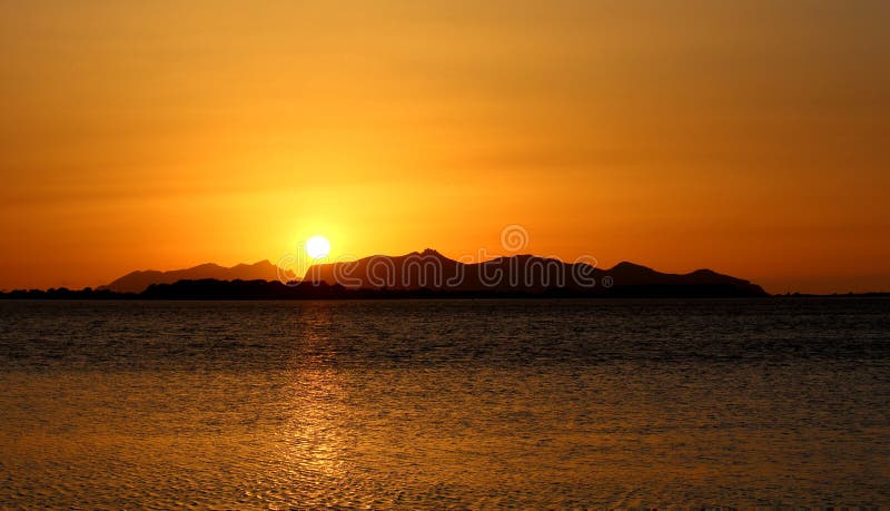 Sunset Over the Sea with Promontory in the Background Stock Image ...
