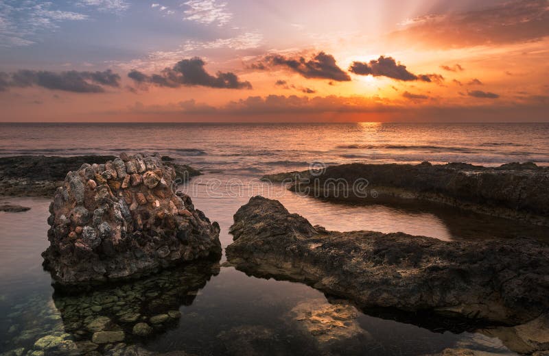 Sunset Over the Sea and Rocky Coast with Ancient Ruins Stock Photo ...