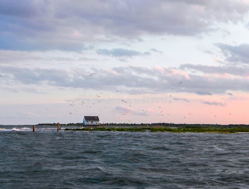 Sunset Over a Seaside Cottage Stock Photo - Image of clouds, cottage ...