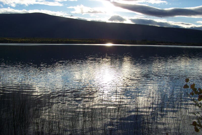 Sunset Over the Shimmering Waters Stock Photo - Image of cloud, designs ...