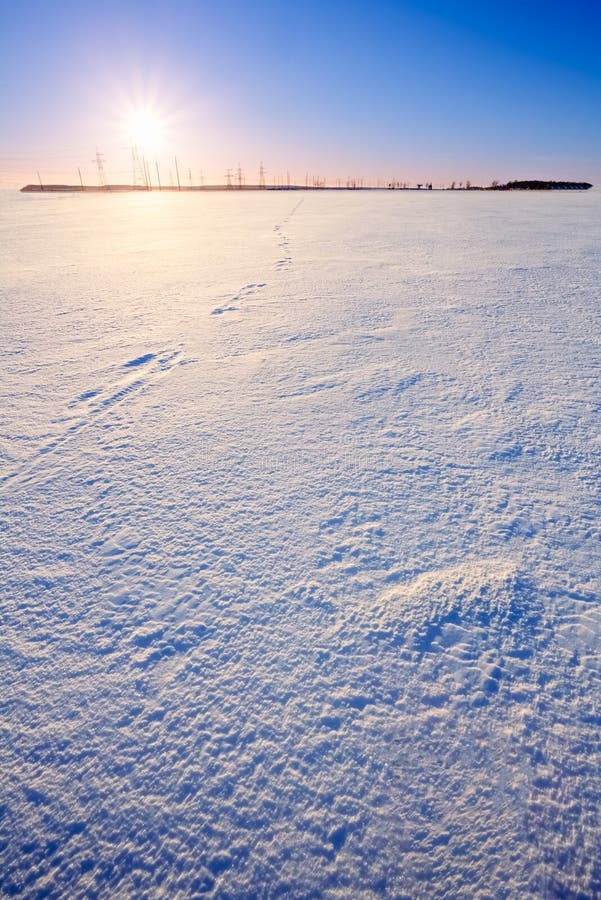 Sunset Over a Smooth Field with Snow Stock Photo - Image of power ...