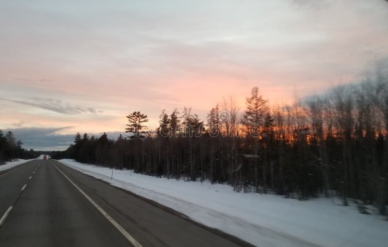 Sunset over the treeline stock image. Image of driving - 182265527