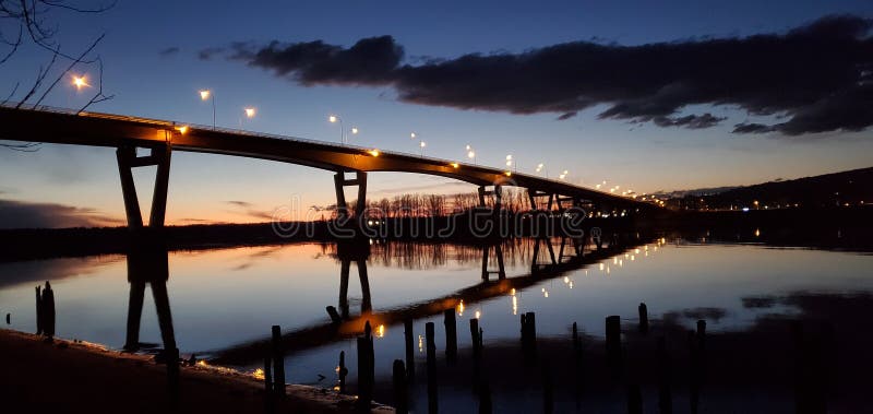 Sunset Over Water and Bridge Stock Photo - Image of reflection, river ...