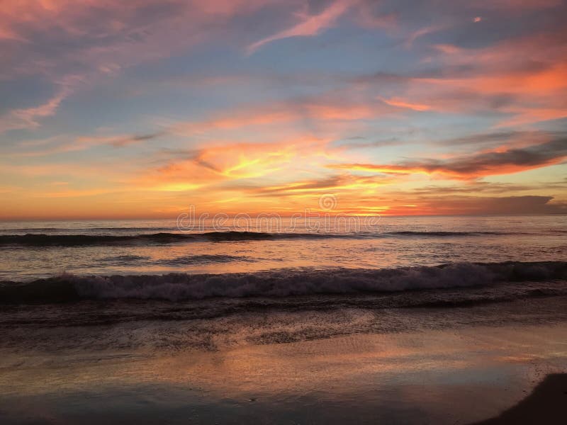 Sunset over waves stock image. Image of blue, orange - 144716621