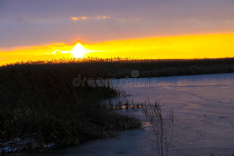 Sunset over a winter river stock image. Image of season - 99931941