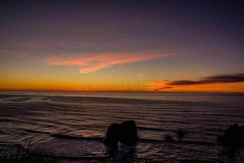 Sunset through the Pacific Surf. Top of the Waves are Being Blow Off in ...