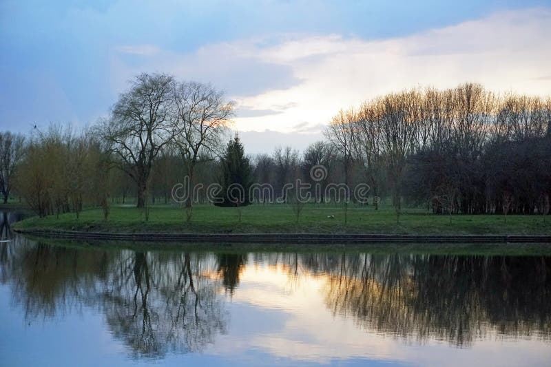 Sunset in the Park by the Pond. Reflection and Spring Mood Stock Image ...
