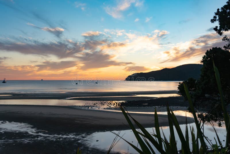 Sunset Patterns As Clouds and Sun Backlight and Brighten Tidal Beach ...