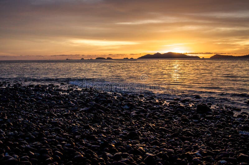 Sunset on pebble beach stock photo. Image of pebble, beautiful - 82924182