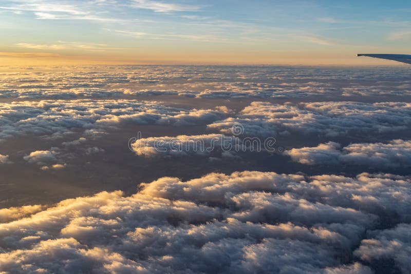 Wing of a plane at sunset stock photo. Image of takeoff - 143202422
