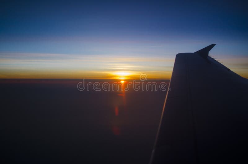 Sunset from a plane stock image. Image of peaceful, cloudy - 166192011