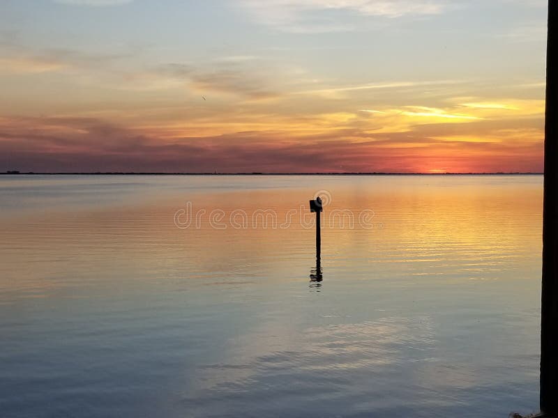 Sunset on a Post stock photo. Image of sunset, ocean - 122818796