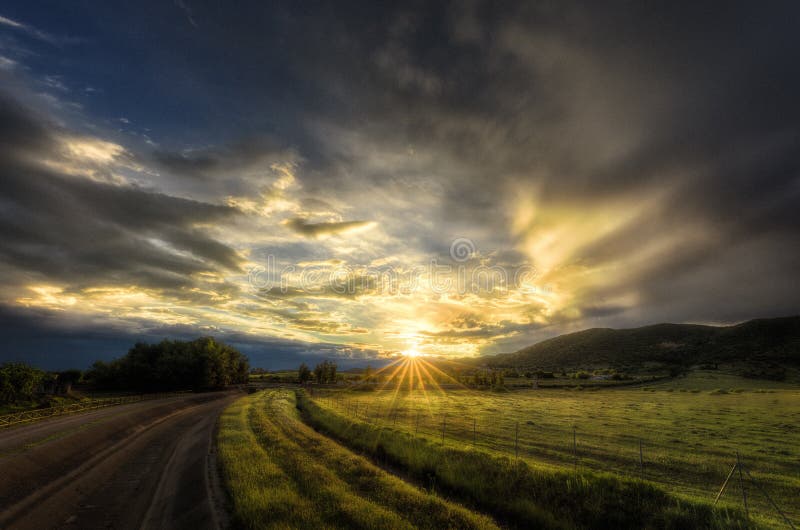 Sunset Rays in a Beautiful Green Meadow Stock Image - Image of ...