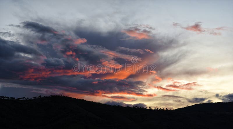 Sunset with Red Clouds and Mountains on the Horizon Stock Image - Image ...