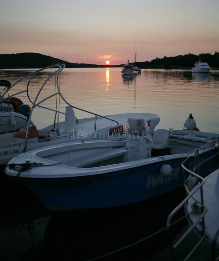Sunset Reflected in the Sea in the Harbour with Ships in the Foreground ...