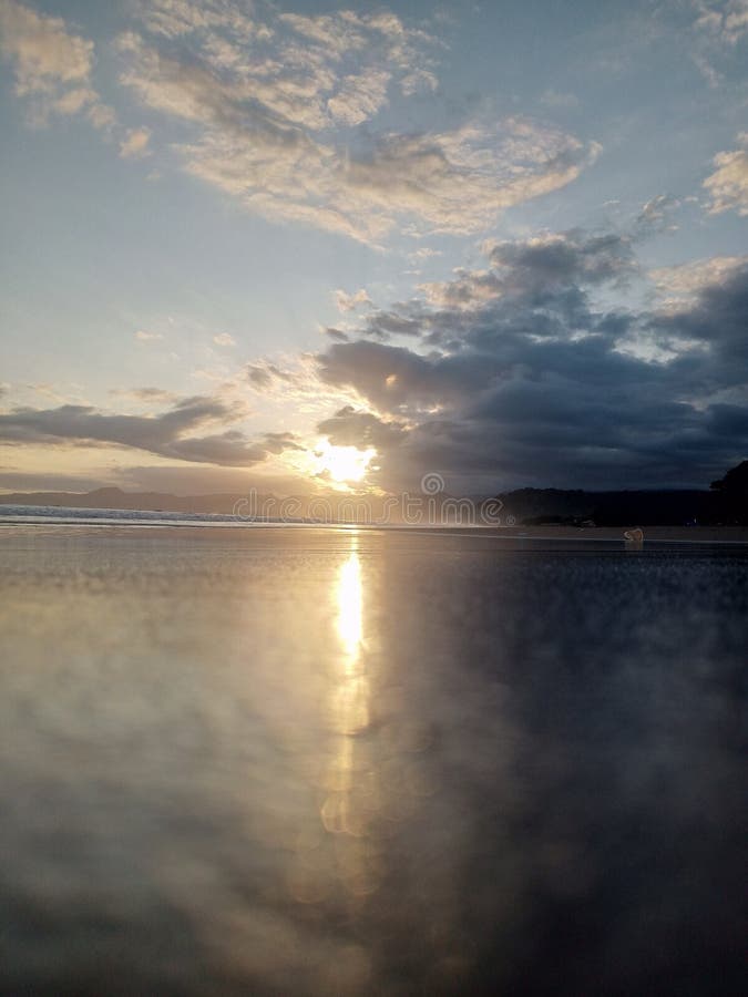 Sunset Reflection on the Beach with Cloudy Sky Stock Photo - Image of ...