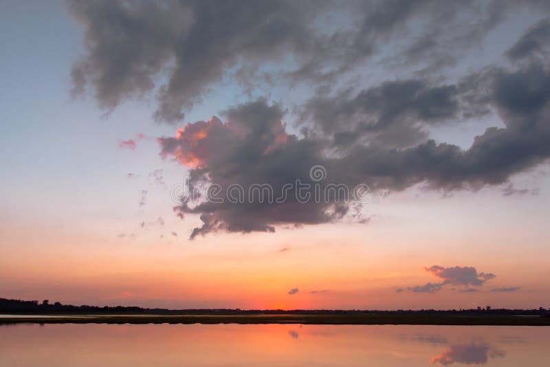 Sunset Reflection Lagoon. Beautiful Sunset Behind the Clouds and Blue ...