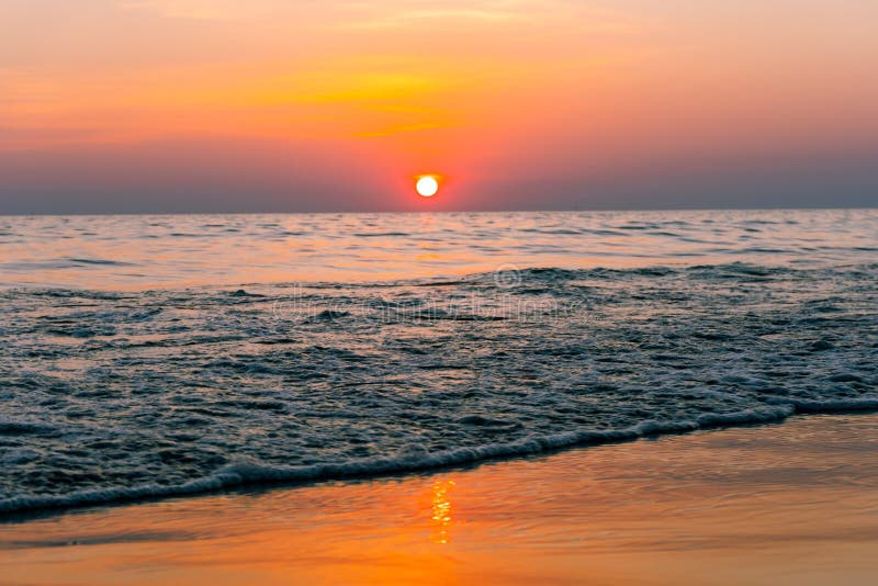 Sunset Reflection Sea. Beautiful Sunset Behind the Clouds and Blue Sky ...