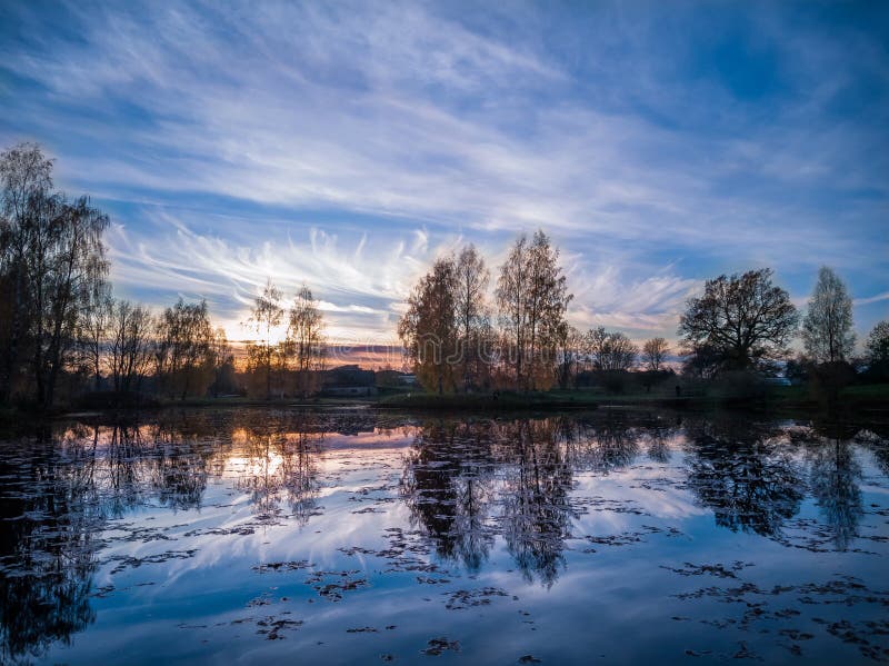 Sunset reflection in water stock image. Image of symetric - 107085751